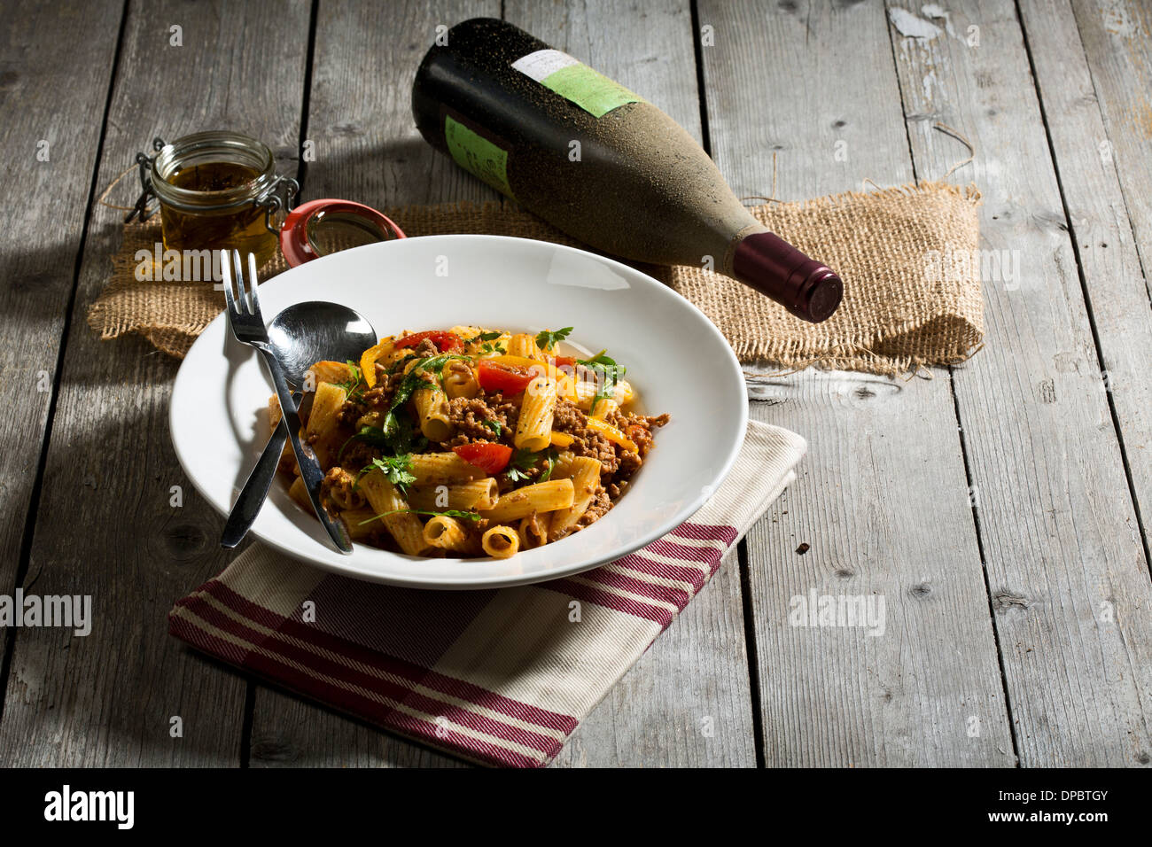 Tortiglioni with mincemeat, paprika, tomato, and rucola Stock Photo - Alamy