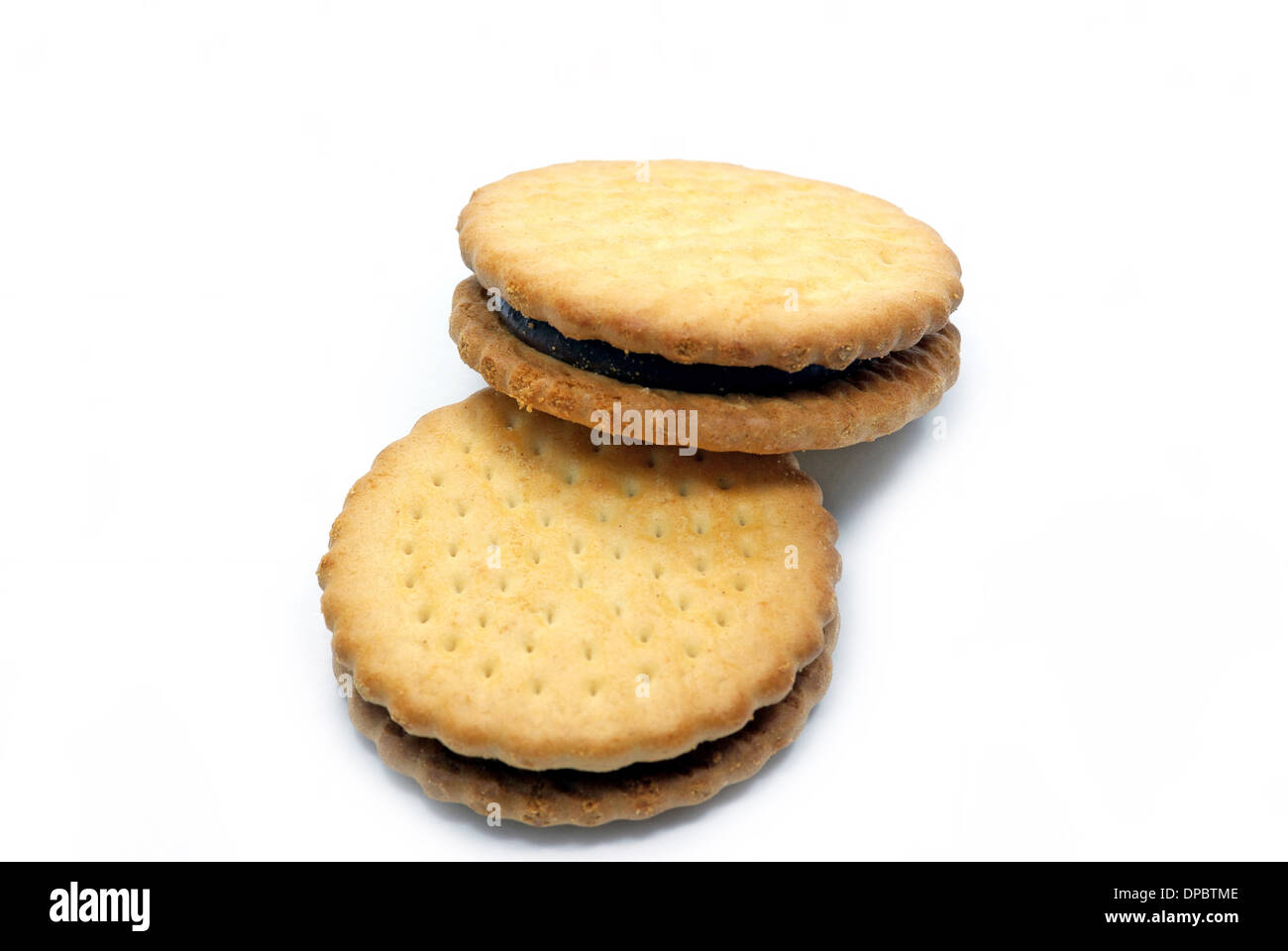 Two biscuits with cocoa filling on white Stock Photo - Alamy