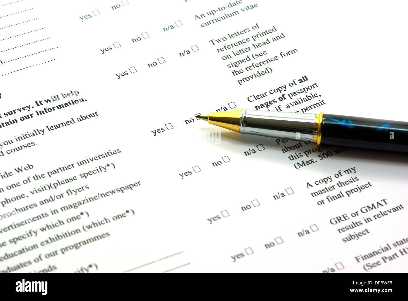 Completing application form with pen in education Stock Photo - Alamy