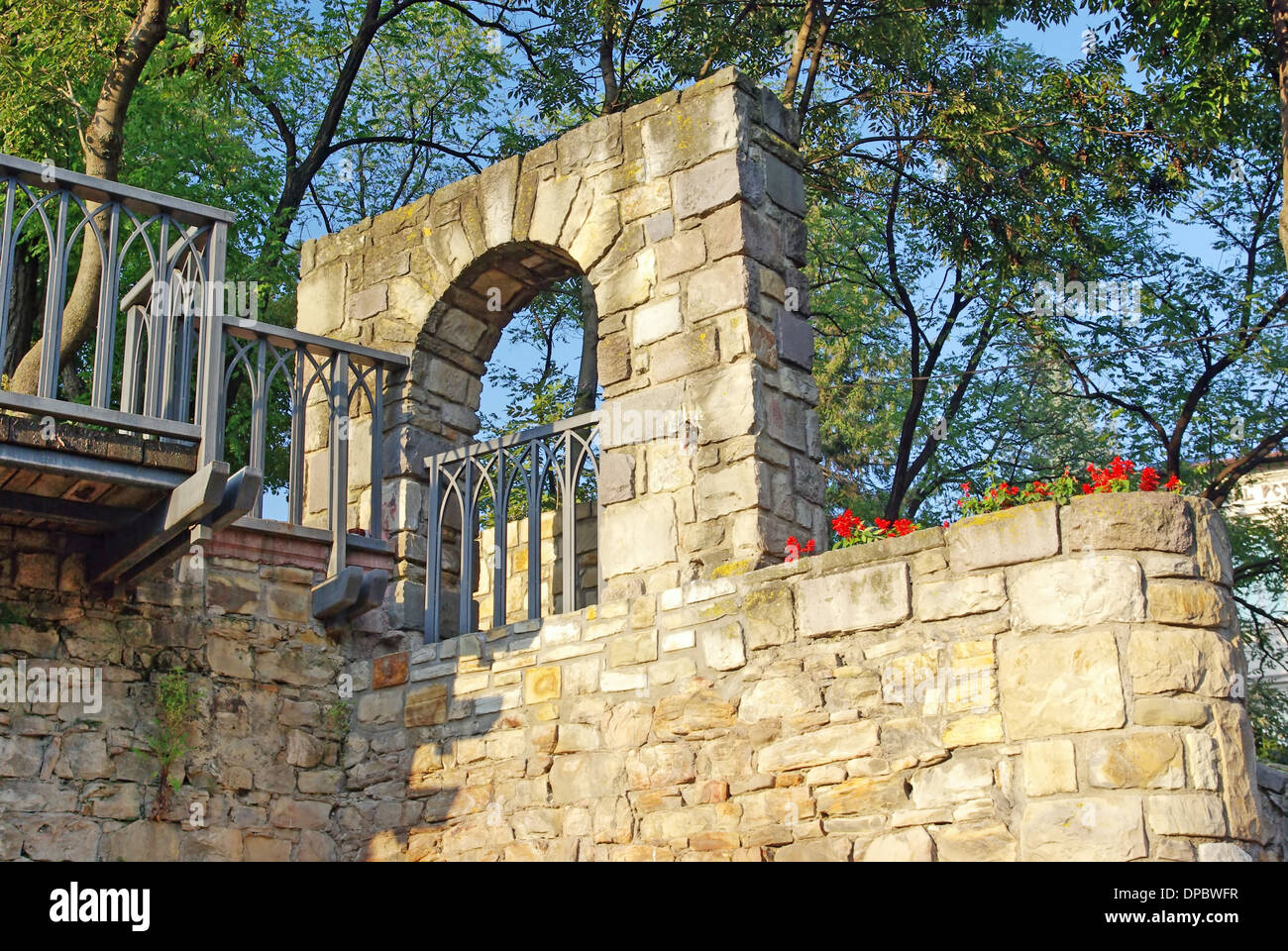 Medieval complex stone wall with flowers in summer Stock Photo - Alamy