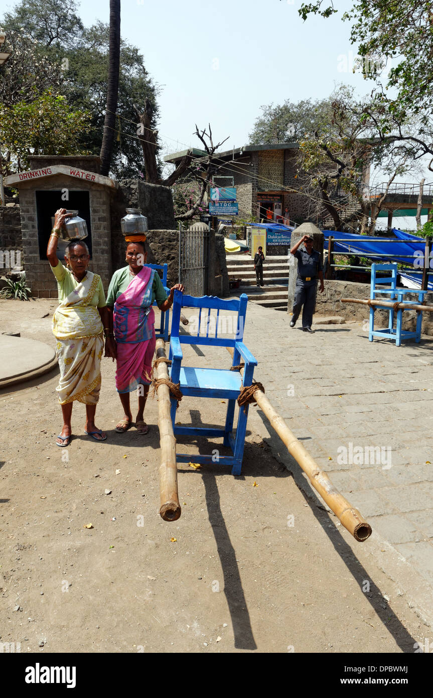Woman carrying chair on head hi-res stock photography and images - Alamy