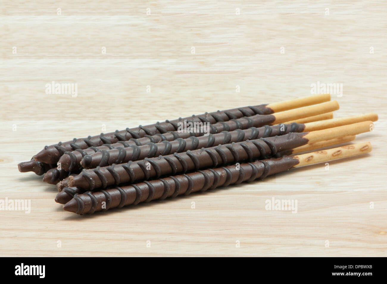 elongated chocolate cookies on a wooden background Stock Photo - Alamy
