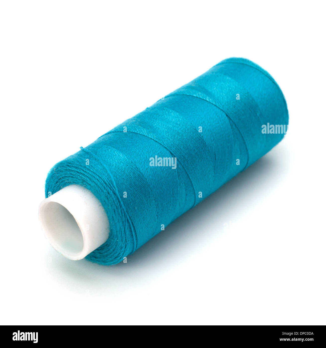 Blue spool of thread isolated on white background Stock Photo - Alamy