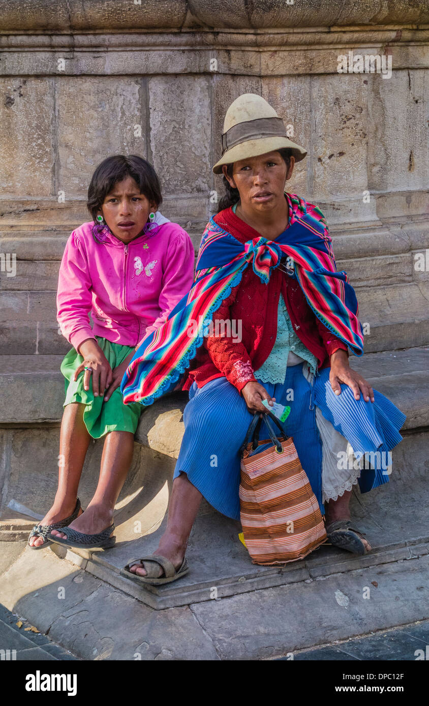 An indigenous woman dressed in traditional clothing in a colorful shawl ...