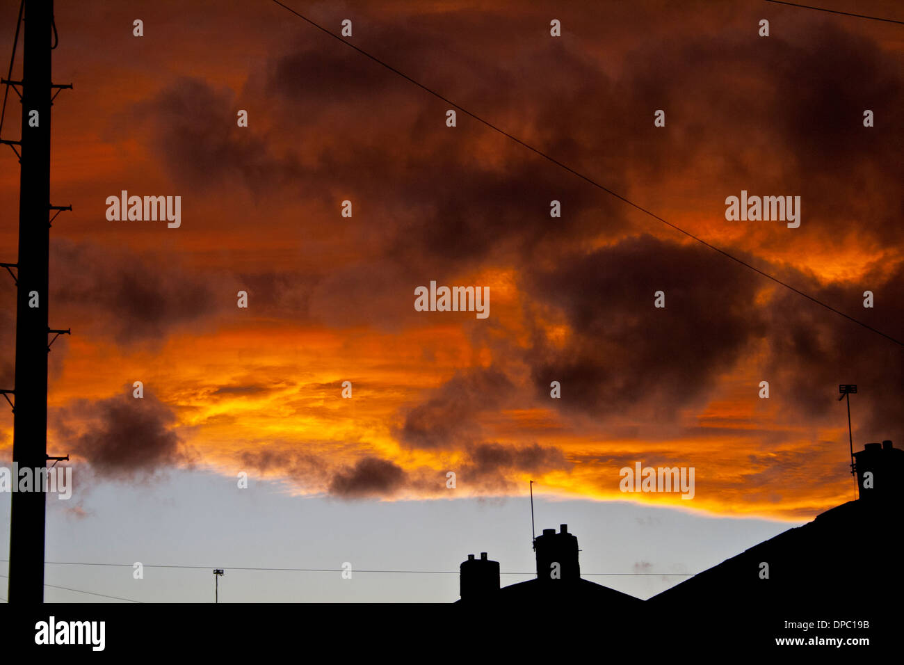 Orange sky and telephone poles Stock Photo - Alamy