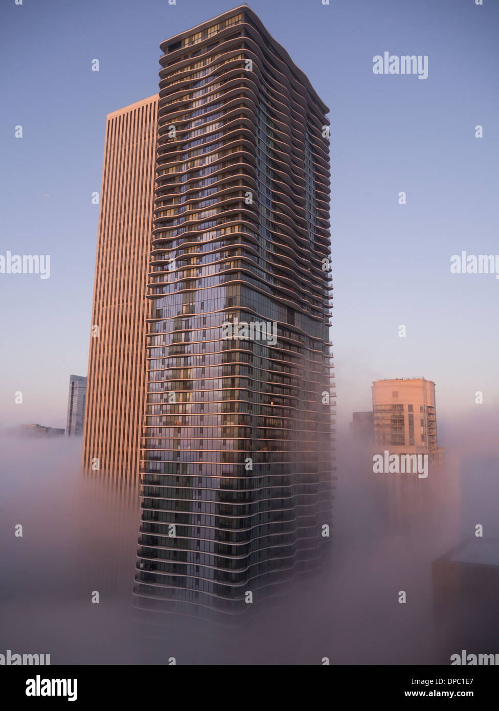 Early morning mist by Lake Michigan. Residential block Aqua rise above ...