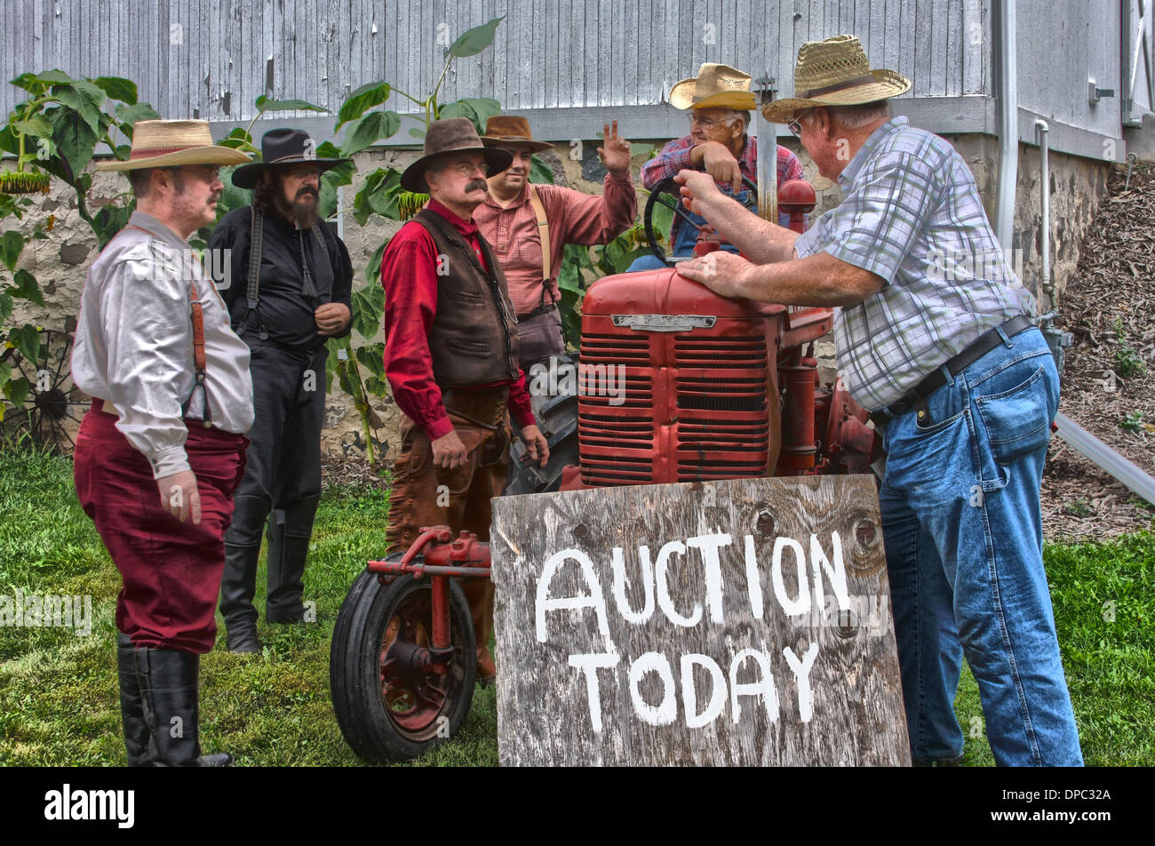 A farm auction today conducted by a auctioner by a barn Stock Photo - Alamy