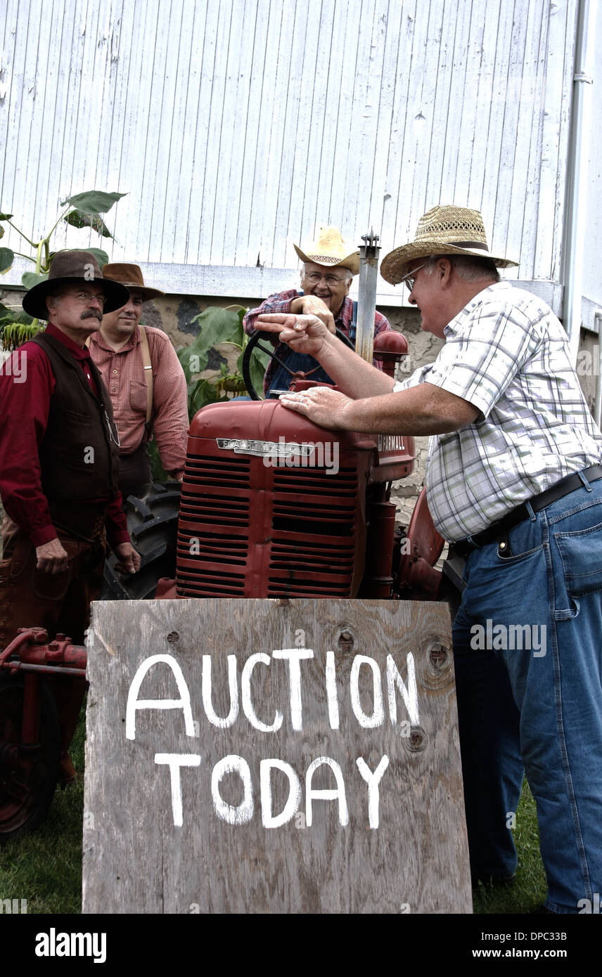 A farm auction today conducted by a auctioner by a barn Stock Photo - Alamy
