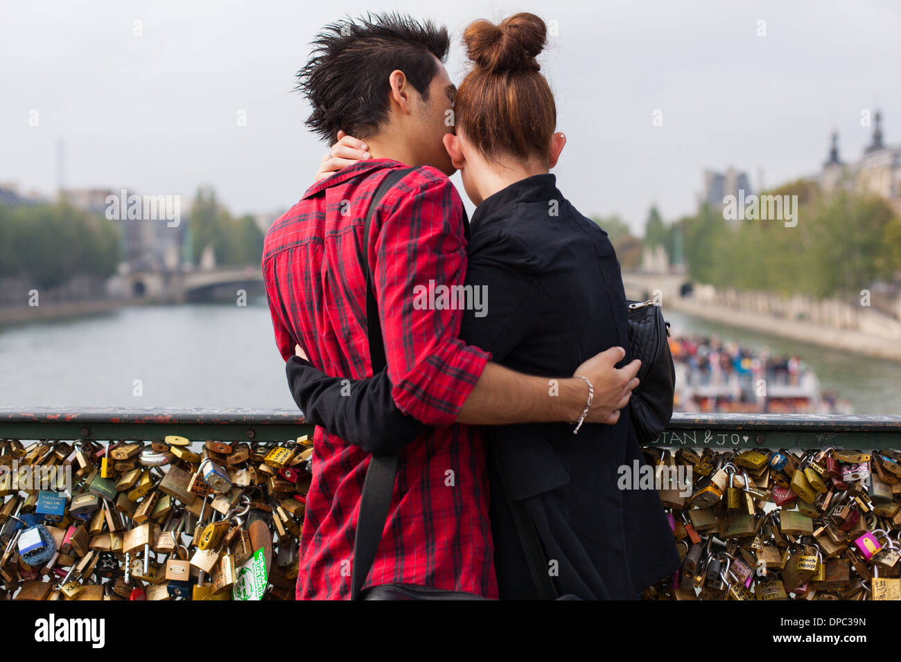 Paris. France. Two lovers embrace each other in front of their love ...