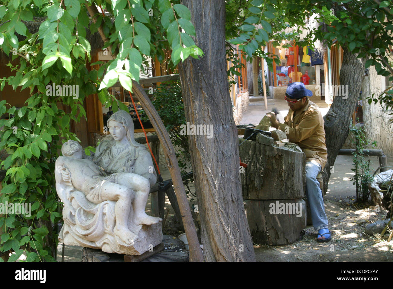 Stone carver at pueblo artesans los dominicos hi-res stock photography ...