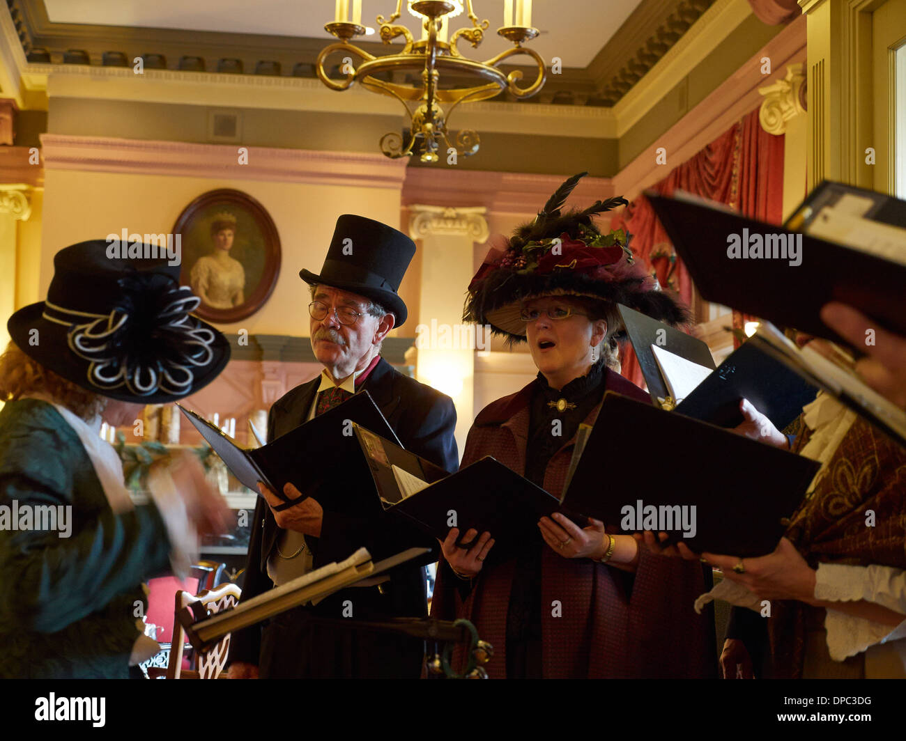 Carol singers in Victorian costumes entertain guests at afternoon tea ...