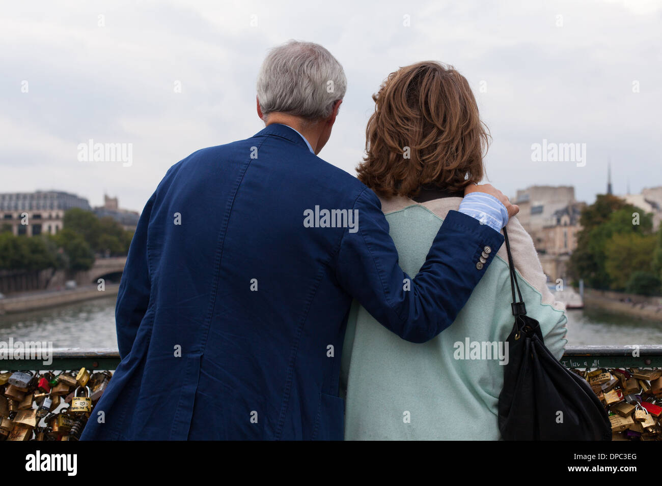 Paris. France. Two old people in love, embracing each other, looking at ...