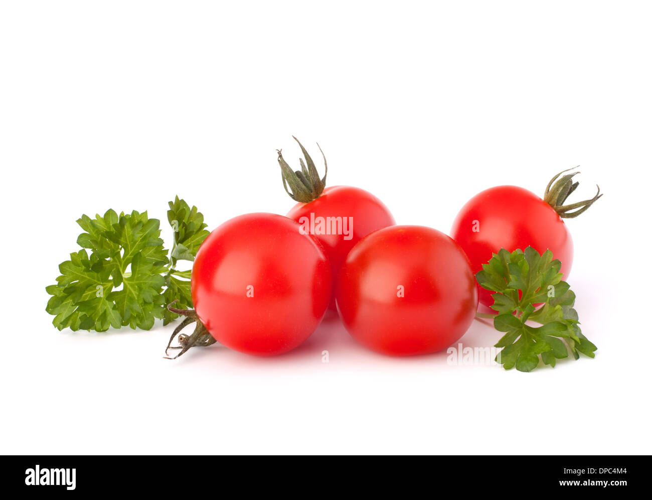 Small cherry tomato and parsley spice on white background close up ...