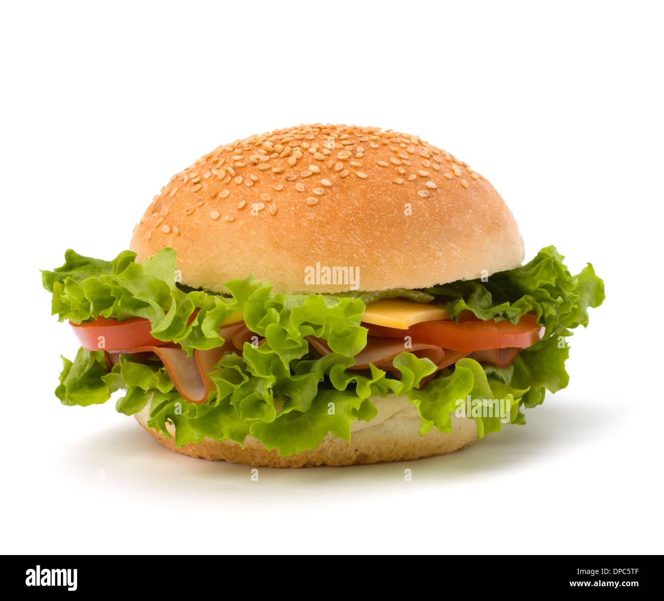 Big appetizing fast food sandwich with lettuce, tomato, smoked ham and ...