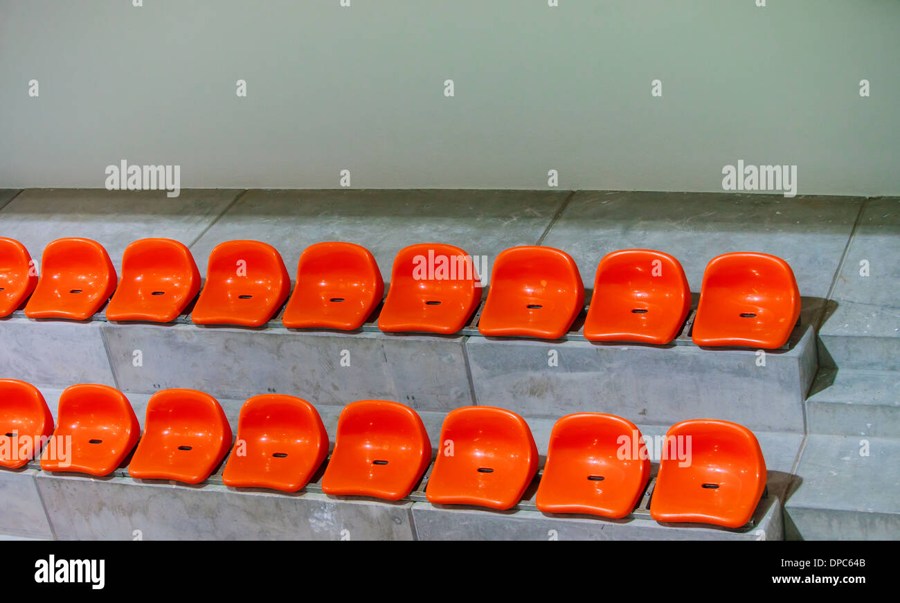 Closeup of red sport stadium seats. Empty stand. Team sport and ...