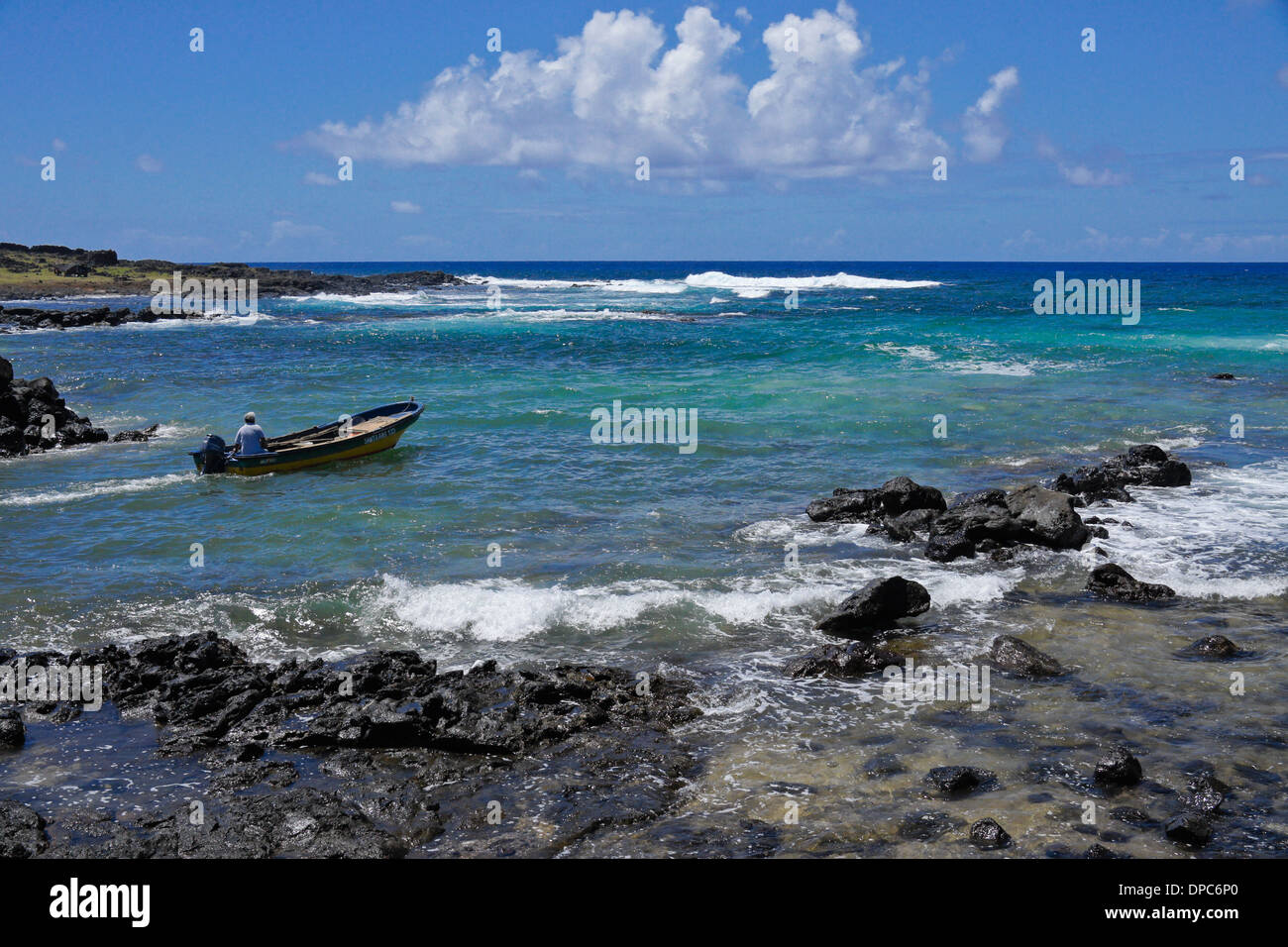 Fishing boat and volcanic shoreline of Easter Island, Chile Stock Photo ...