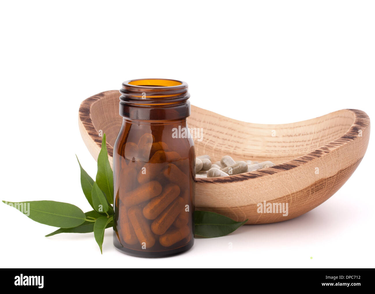 Herbal drug capsules in brown glass bottle isolated on white background ...