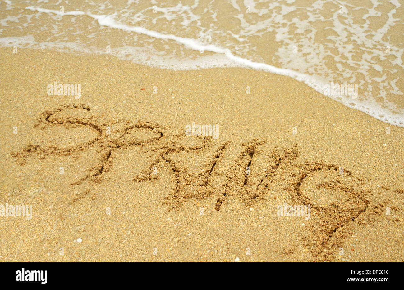 A warm tropical beach for spring break concept and spring written in ...