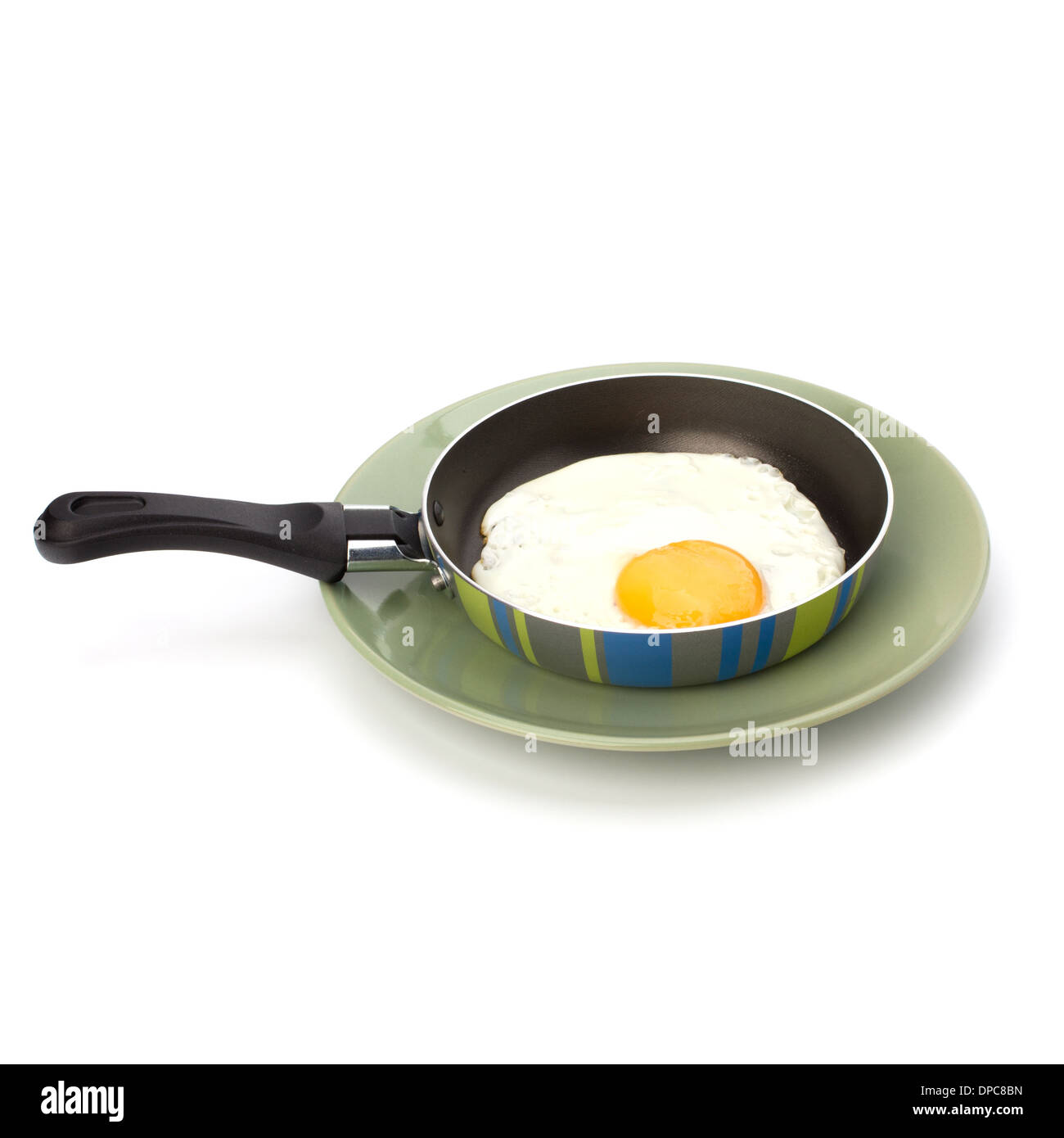 Fried egg on pan over white background Stock Photo - Alamy