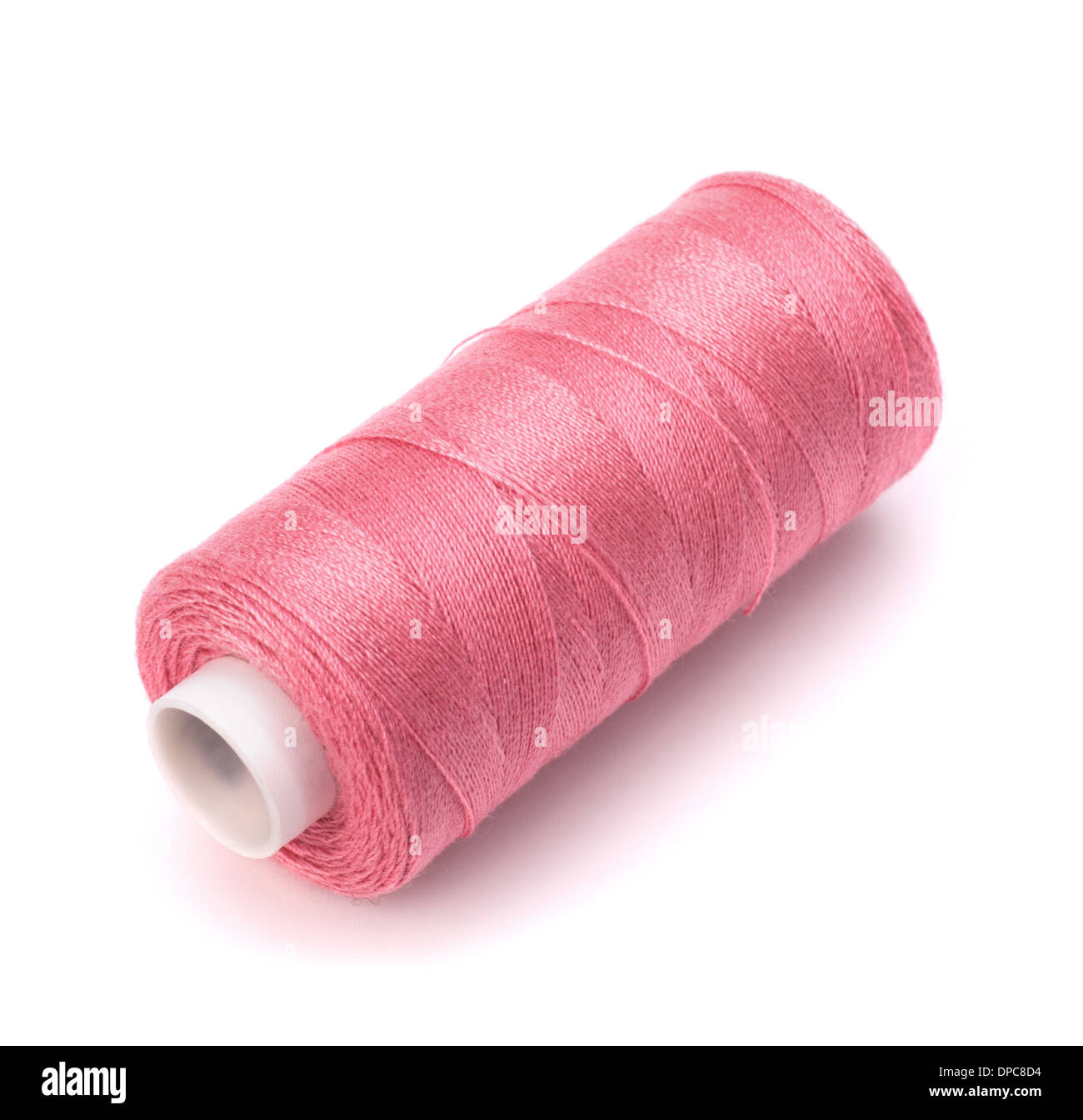 Pink spool of thread isolated on white background Stock Photo - Alamy