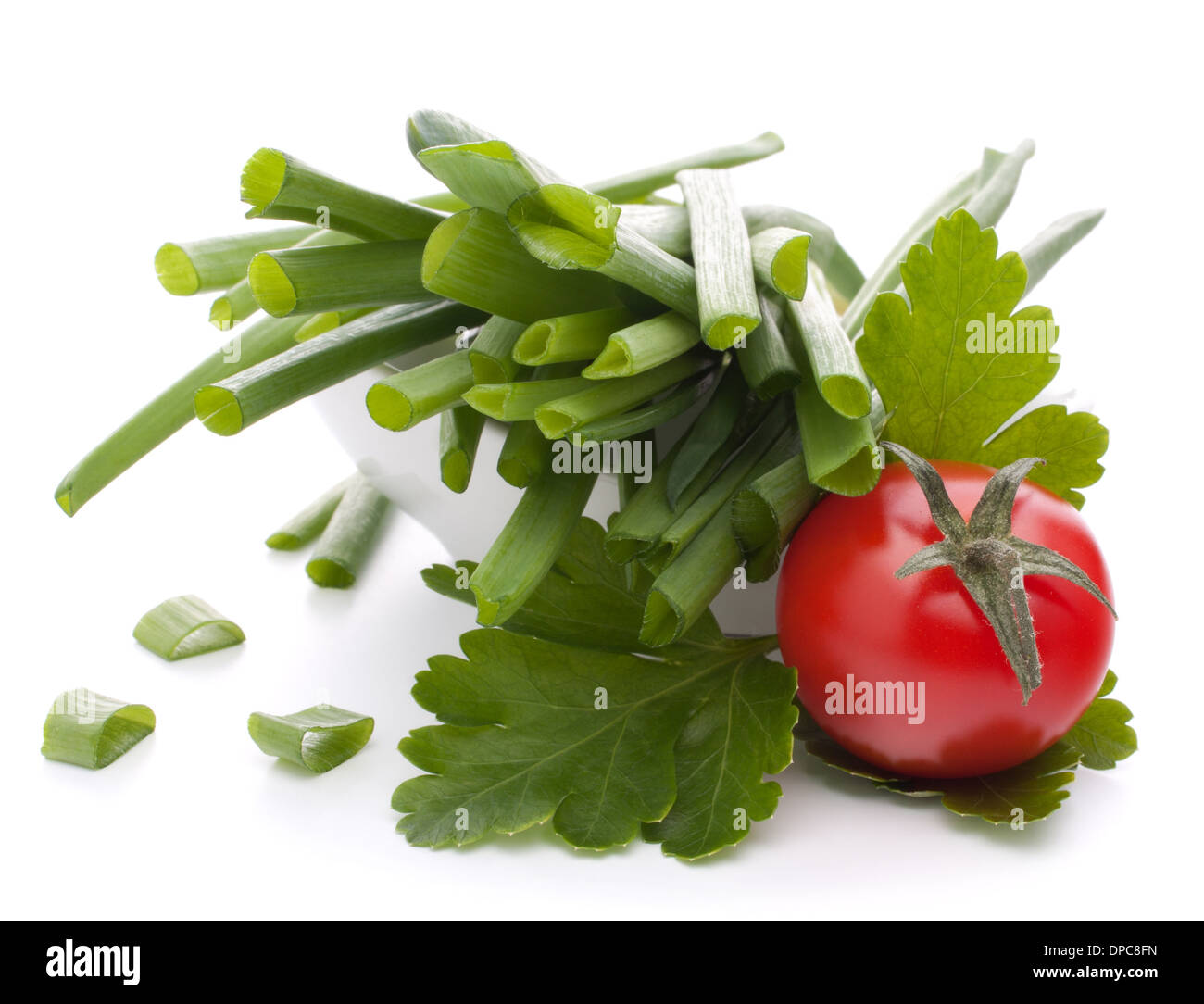 Spring onions and cherry tomato in bowl isolated on white background ...