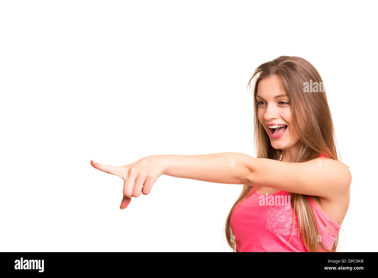 A beautiful woman pointing to something, isolated over a white ...