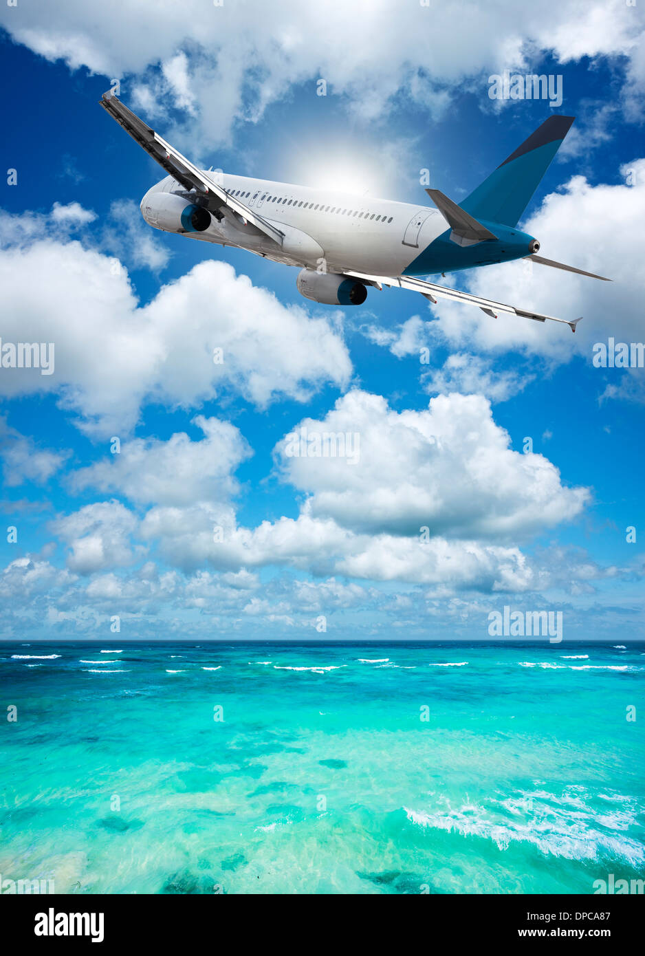 Jet over the tropical sea Stock Photo - Alamy