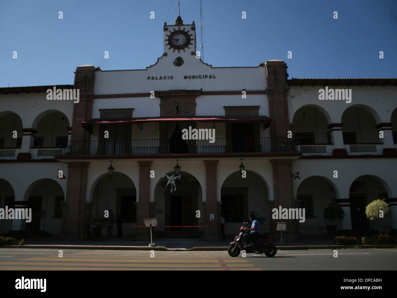 Michoacan, Mexico. 12th Jan, 2014. A motorcycle runs in front of the ...