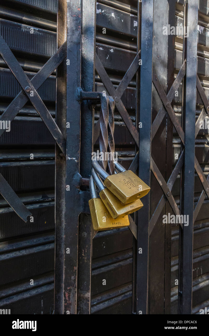 Multiple padlocks secure a store's sliding metal gate in Sucre, Bolivia ...