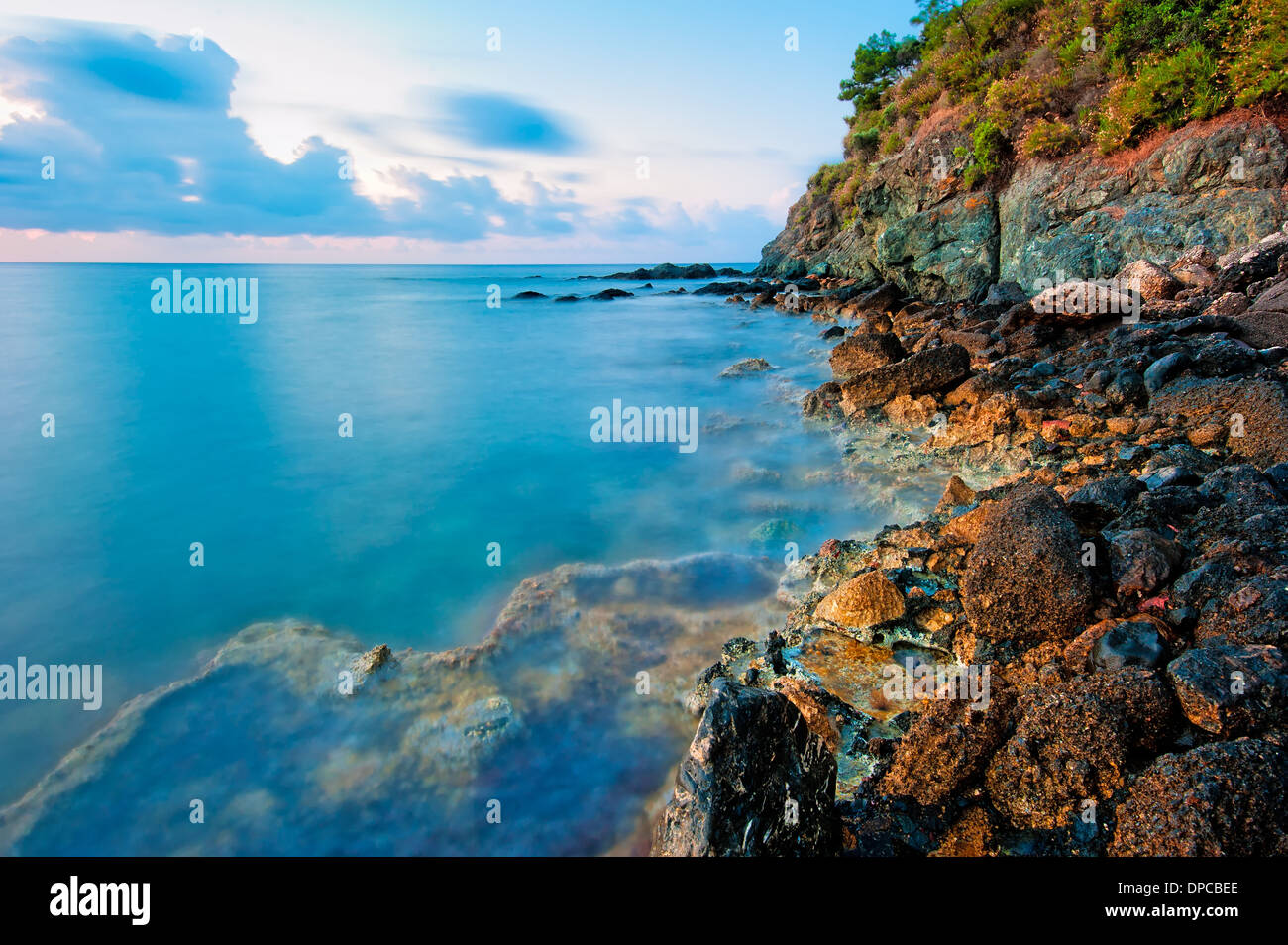 frozen surface of the water and rocky shore Stock Photo - Alamy