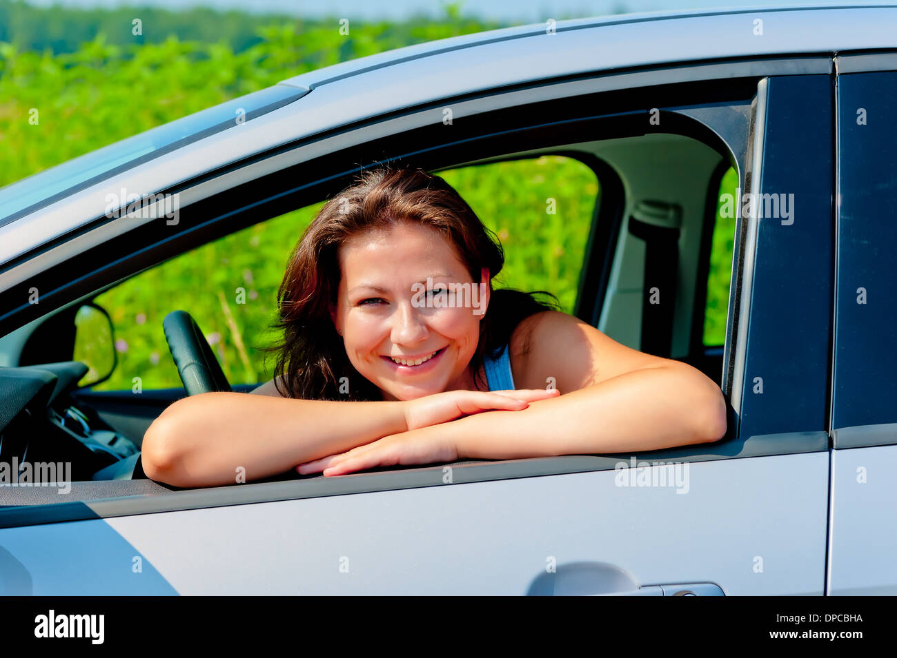 Happy female driver in her new car Stock Photo - Alamy