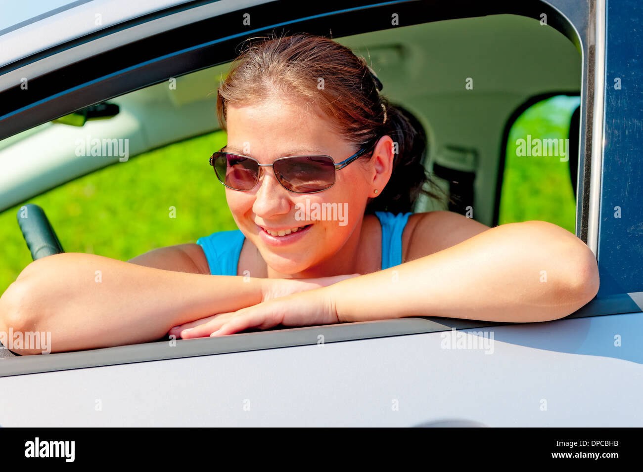 Pretty female driver in her new car Stock Photo - Alamy