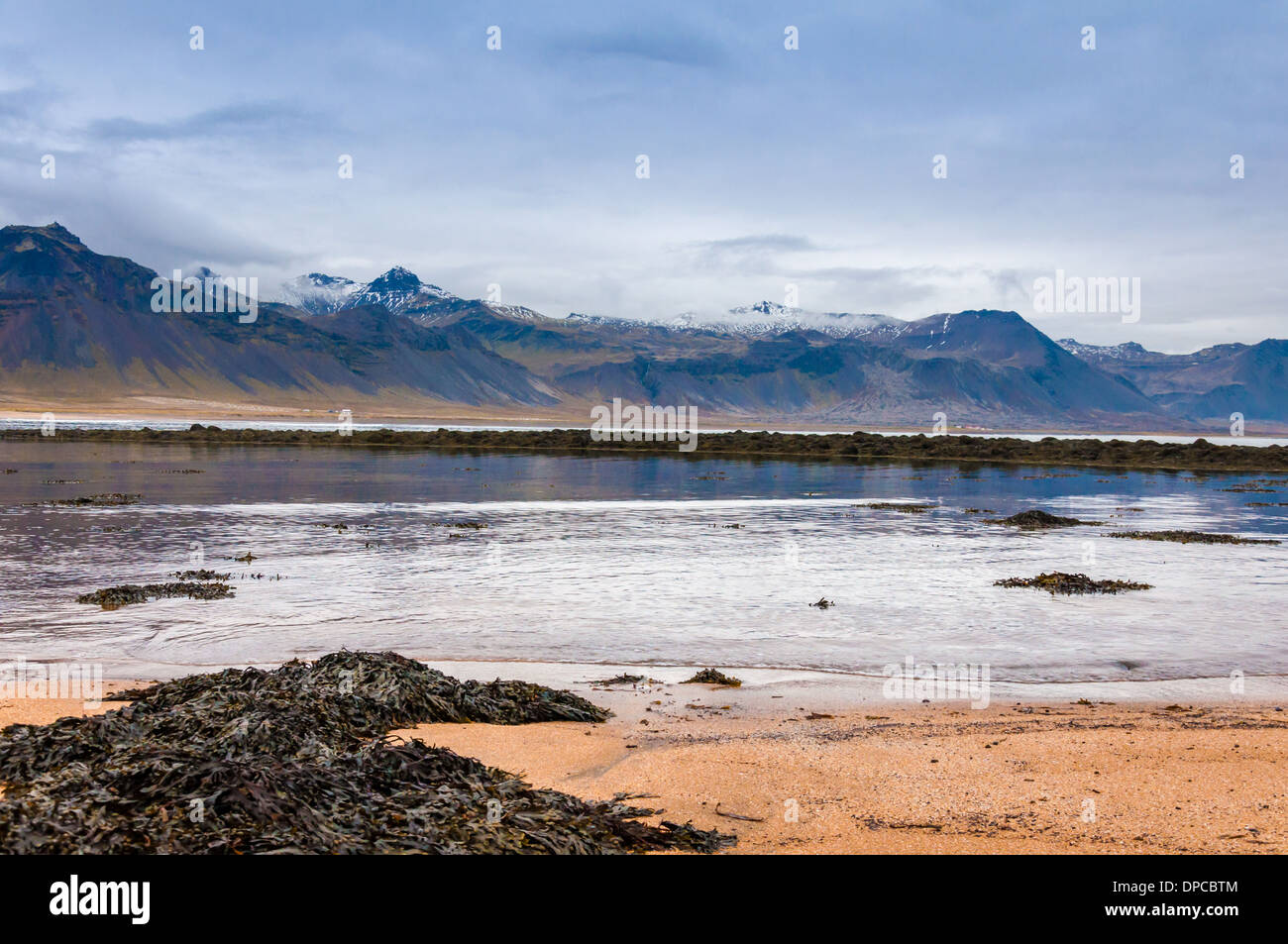Sand beach with black volcanic rocks in Iceland near Budir - small town ...