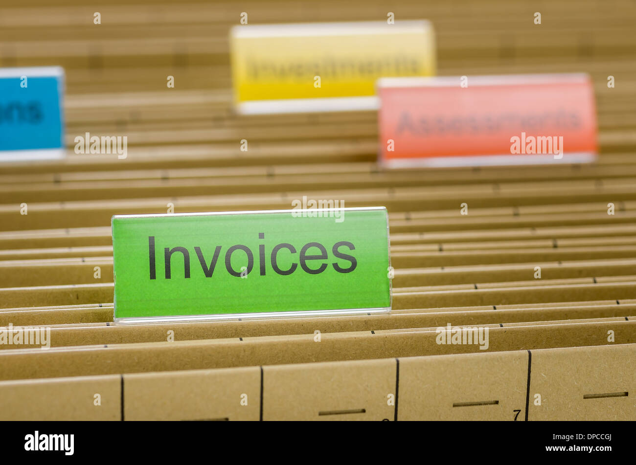 Hanging file folder labeled with Invoices Stock Photo - Alamy