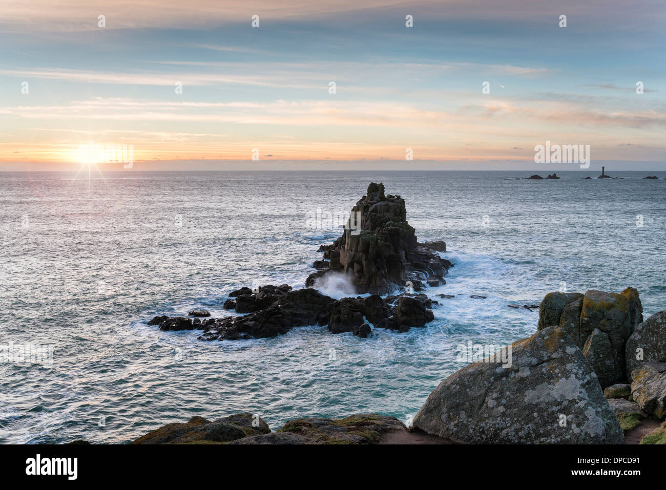 Rocky cliffs at Lands End in Cornwall with the Longships lighthouse in ...