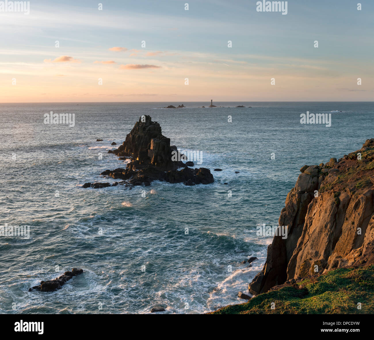 Rocky cliffs at Lands End in Cornwall with the Longships lighthouse in ...