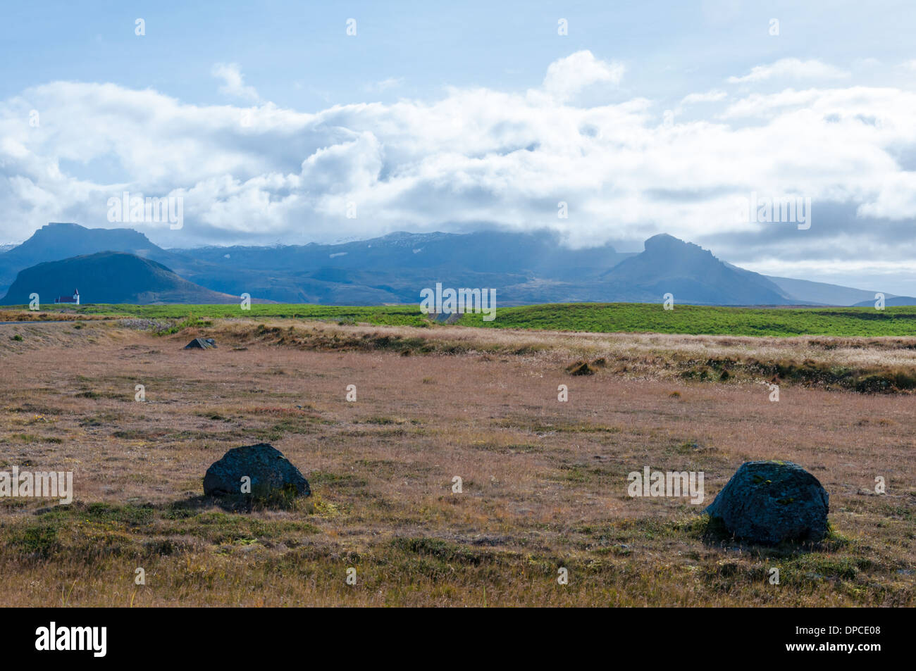 Icelandic landscape with volcanic rocks and green grass Stock Photo - Alamy