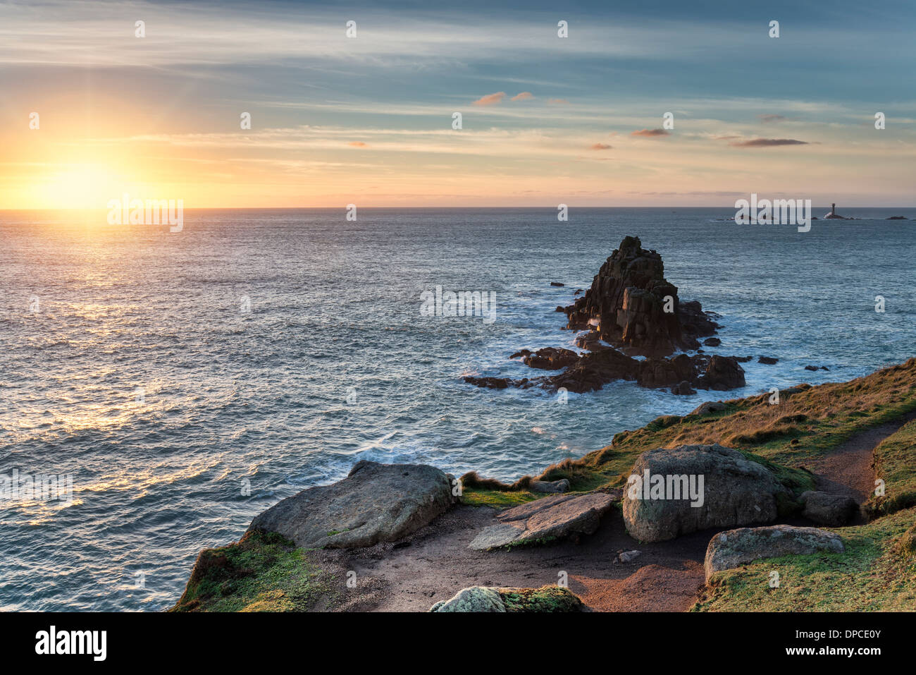 Rocky cliffs at Lands End in Cornwall with the Longships lighthouse in ...