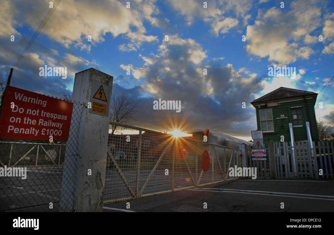 A South Eastern passenger train passes a signal hut at dusk with ...