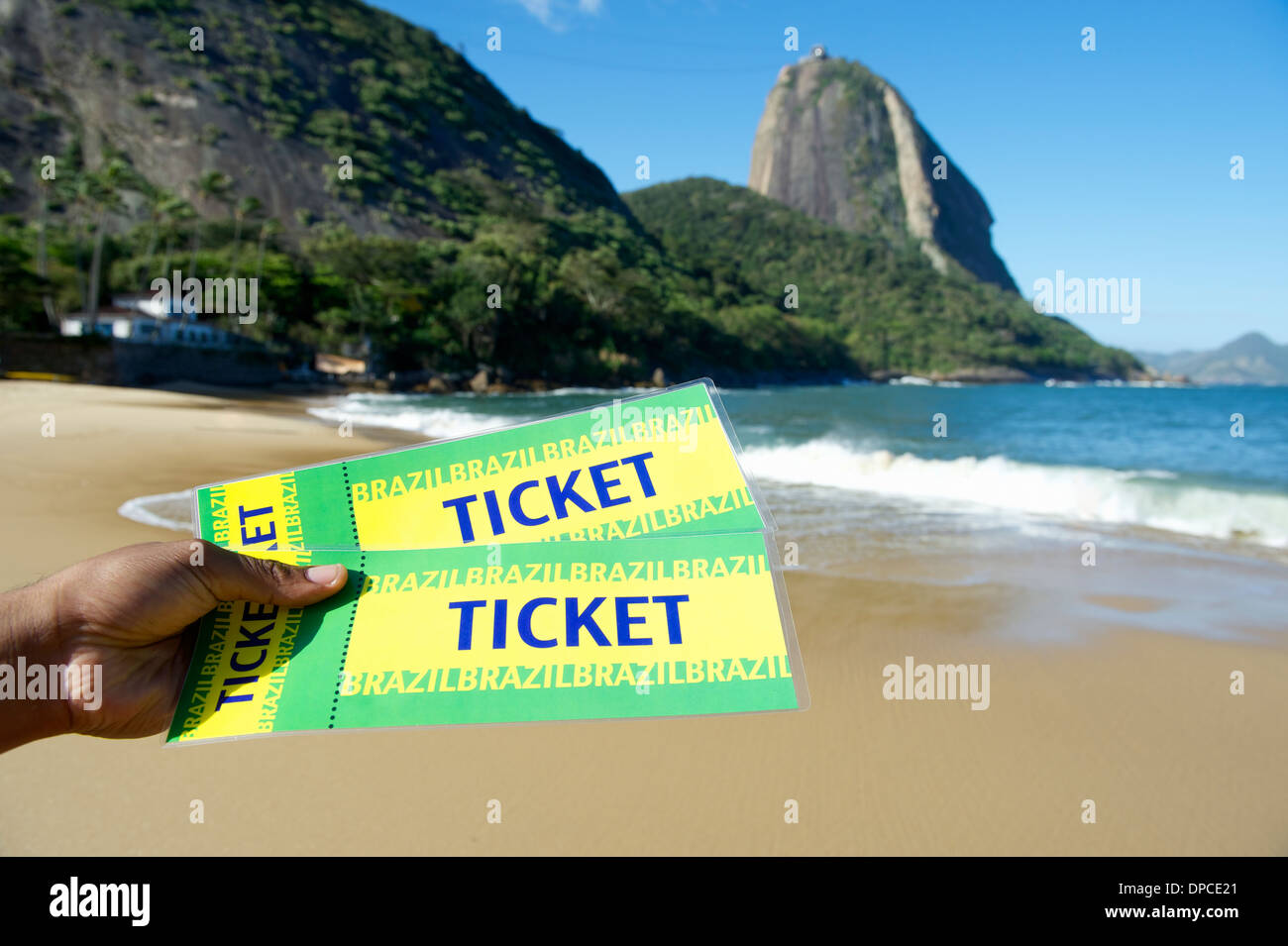 Brazilian hand holding pair of tickets up at Praia Vermelha Red Beach ...