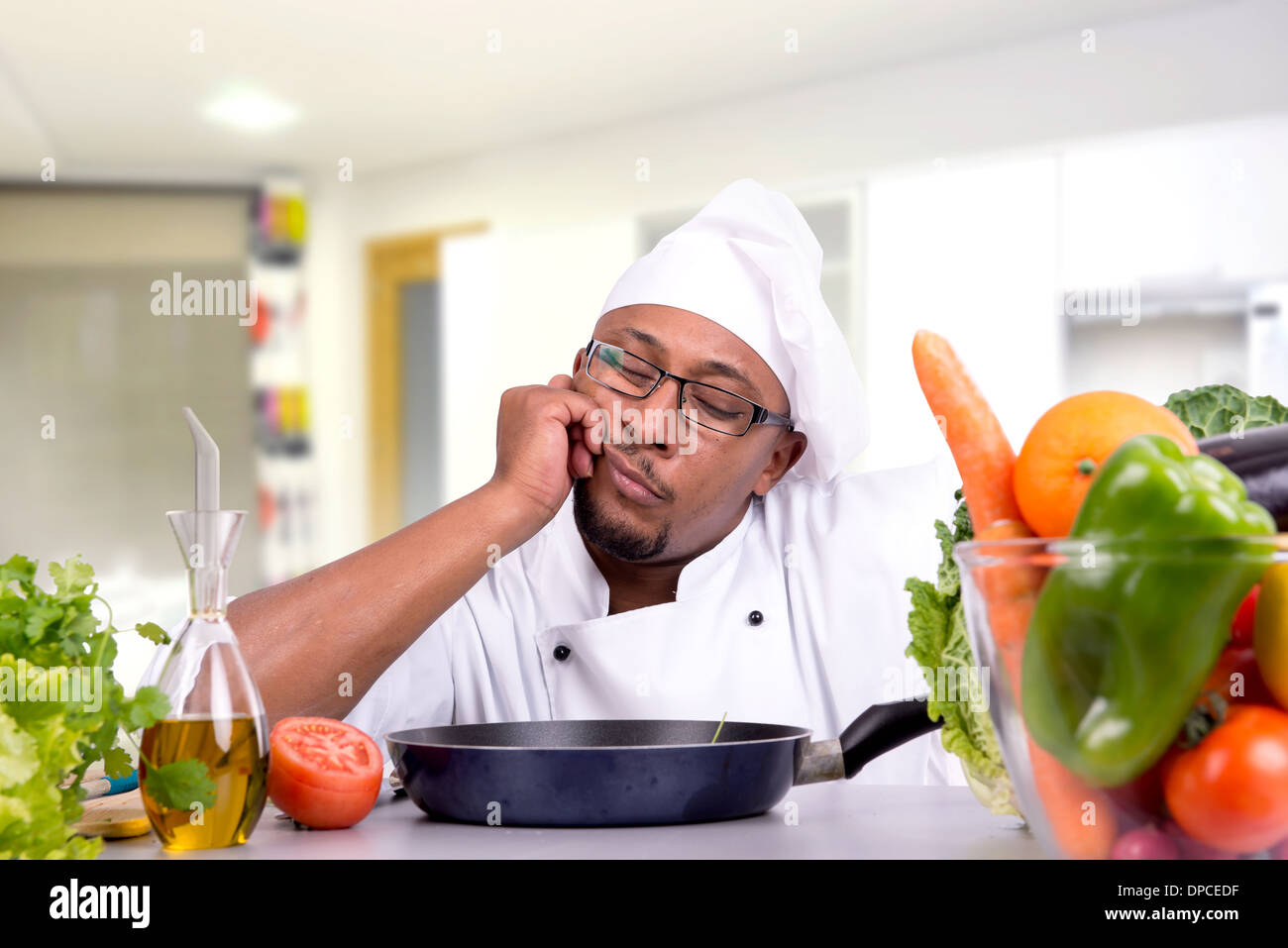Male chef with fruits and vegetables in the kitchen thinking Stock ...