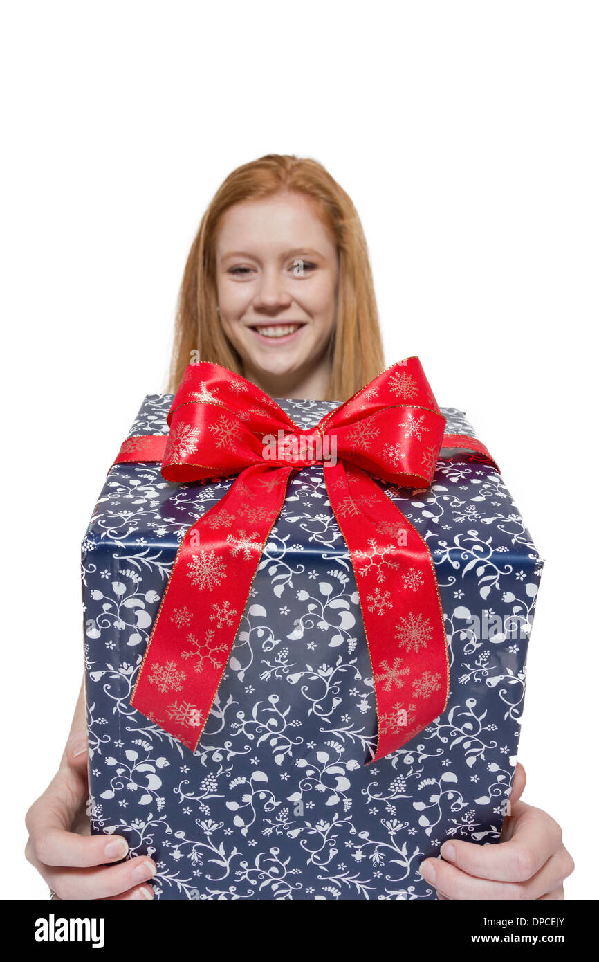 Young well dressed red haired Girl presents present with a big smile ...