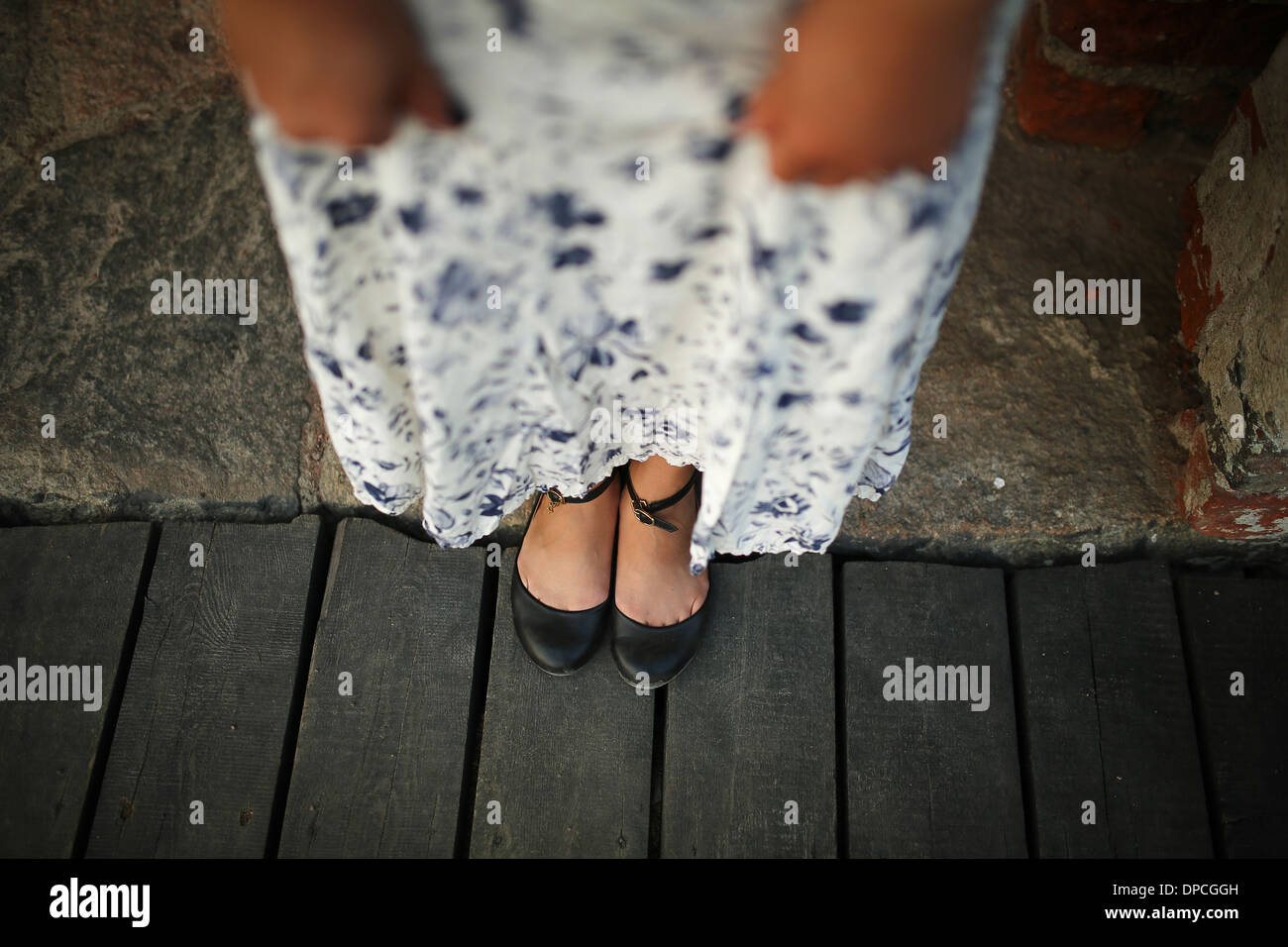 Young asian girl with maxi skirt and feet on a wooden floor Stock Photo ...