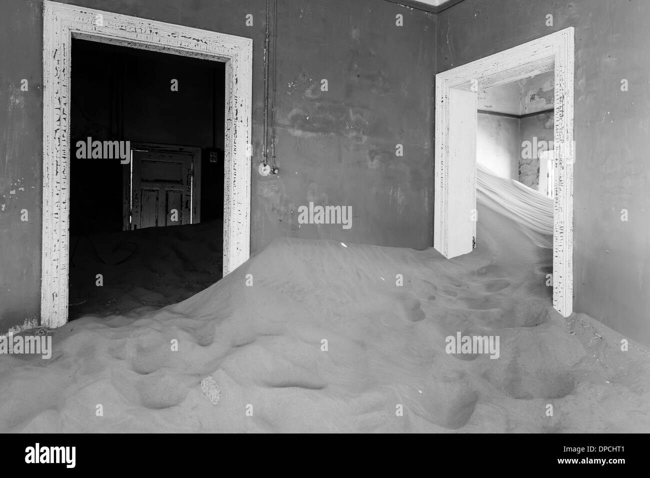 Interior of house filled with sand in ghost town in Namibia desert ...