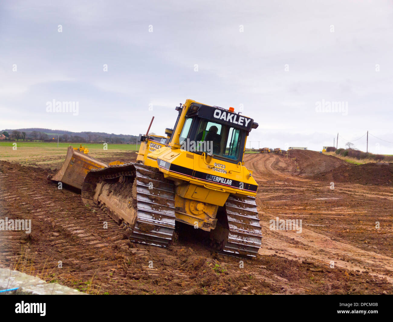 Caterpillar D6M LG bulldozer working on earthworks for construction of ...