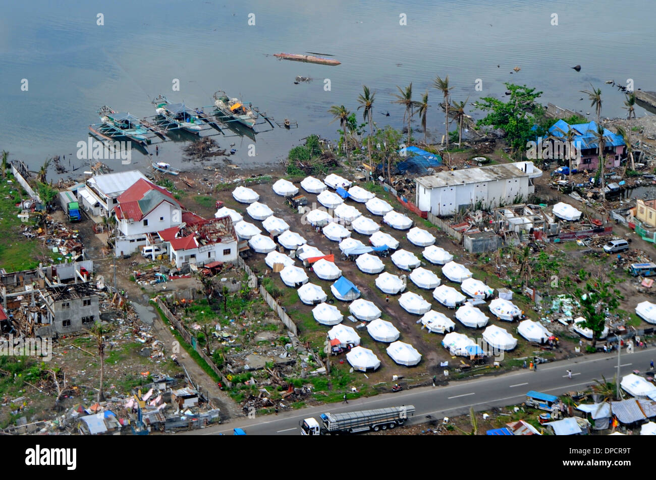 Aerial view of the damage caused by Super Typhoon Haiyan and a refugee ...