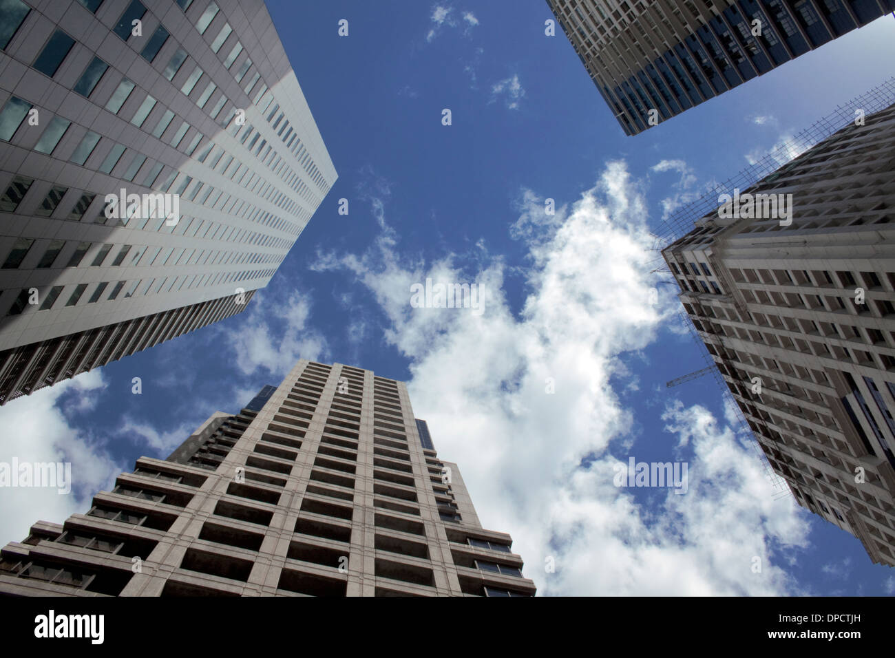 Four tall buildings 'converging' with a bright cloudy sky Stock Photo ...