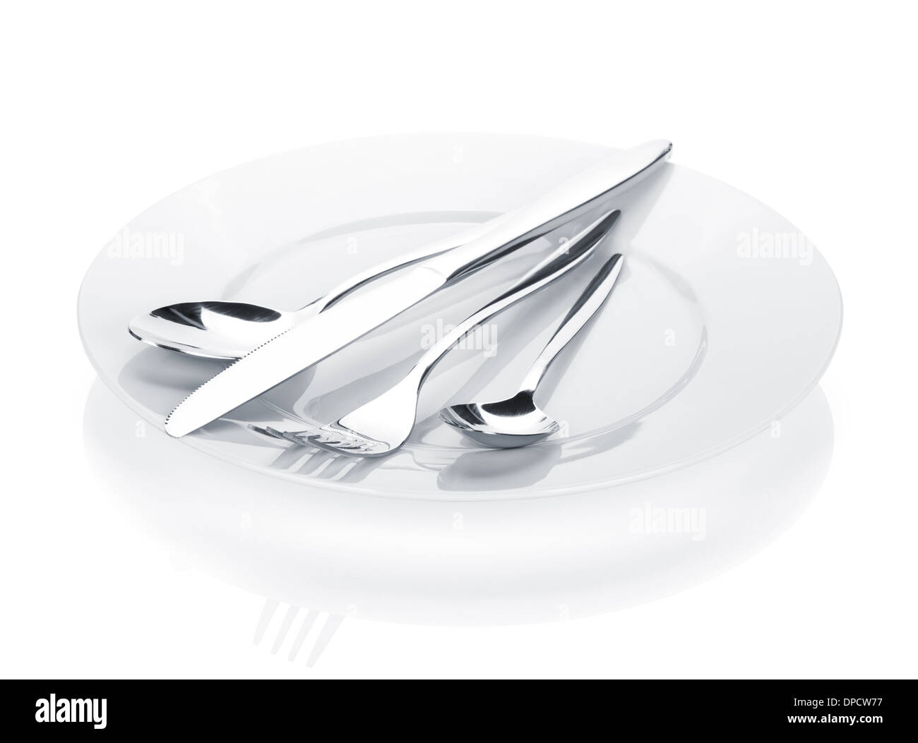 Silverware or flatware set of fork, spoons and knife over plates ...