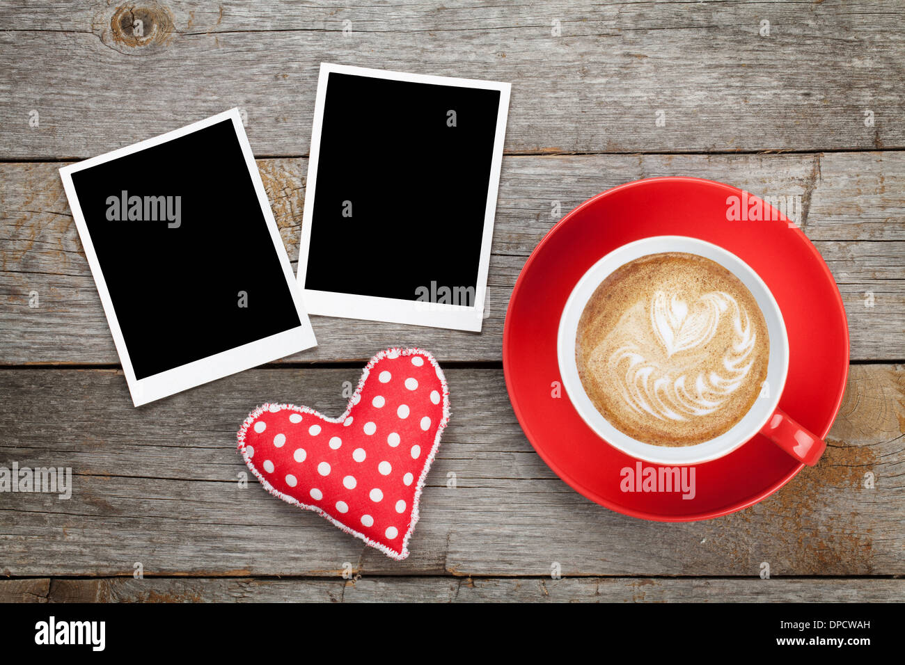 Two photo frames over wooden background with red coffee cup and heart ...