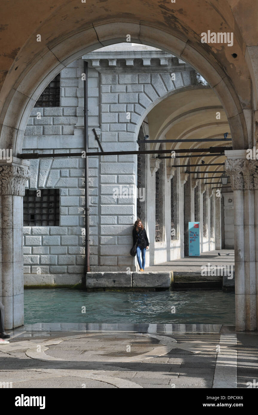 Girl standing next to bridge of sighs over a Venice canal Stock Photo ...
